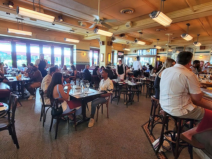 Inside Parc, the bustling energy of a true French brasserie comes alive with warm lighting, bentwood chairs, and conversations 