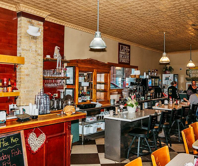 The pressed tin ceiling and warm wood tones create that magical diner atmosphere where conversations flow as freely as the coffee.