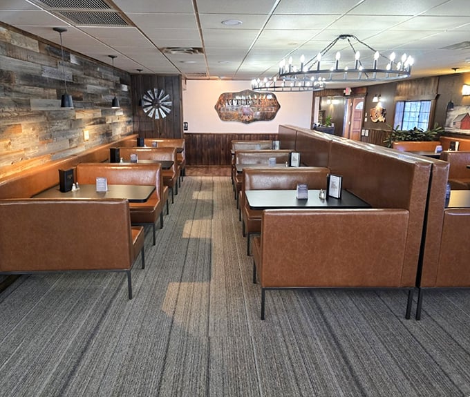 Leather booths that invite you to settle in for the long haul, with wood-paneled walls that whisper tales of celebrations past. The wagon wheel chandeliers are just the right touch of Western without going full rodeo.