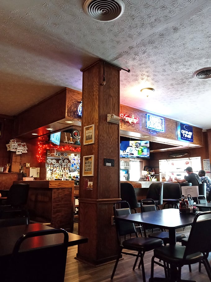 Step inside and time slows down—wood paneling, neon beer signs, and the promise of honest food create the perfect backdrop for burger enlightenment.