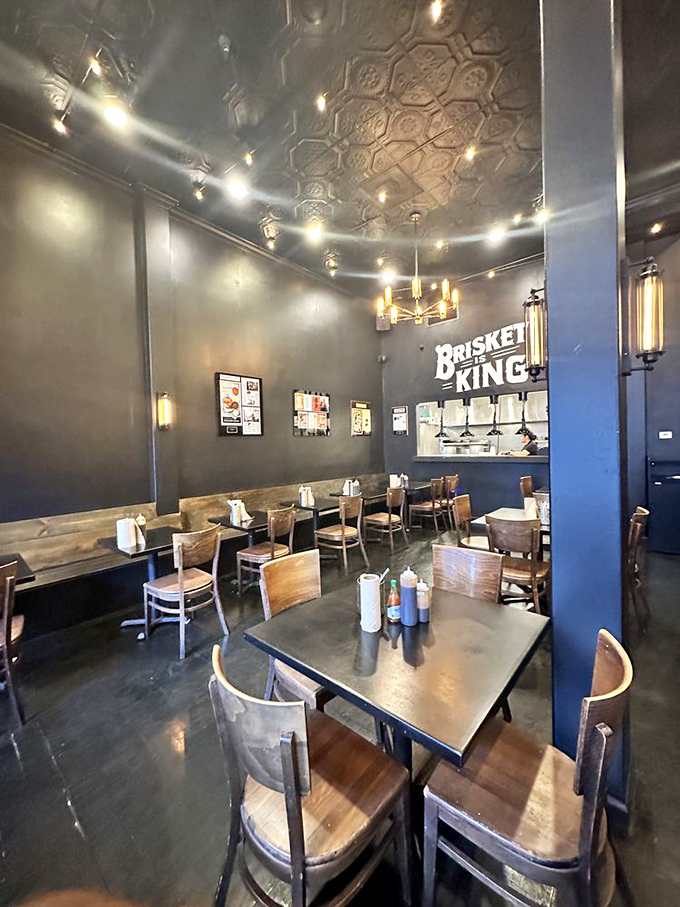 Industrial-chic meets barbecue tradition under that gorgeous pressed tin ceiling. The "Brisket King" sign isn't just decoration&mdash;it's truth in advertising.