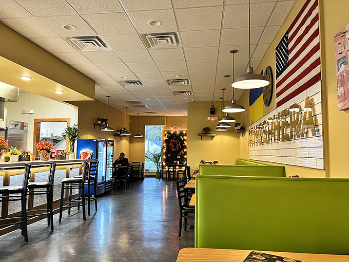 Bright yellow walls and green booths create a cheerful vibe that says, "Forget fancy, we're here for the food!" American and Ukrainian flags unite in culinary harmony.