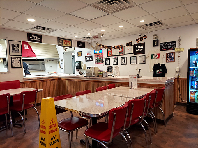 Classic red vinyl chairs and wood paneling create the perfect time capsule. This isn't retro by design&mdash;it's authentic by persistence.