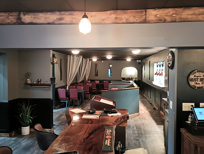 Warm wood tones, exposed beams, and thoughtful lighting create that perfect "welcome home" feeling&mdash;if your home happened to serve incredible steaks.