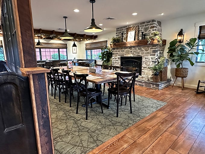 Rustic wooden beams meet stone fireplace in this dining room where comfort isn't just on the menu—it's built into the very walls.