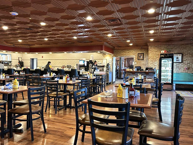 Warm wood floors, exposed brick, and that stunning coffered ceiling create the perfect backdrop for comfort food magic.