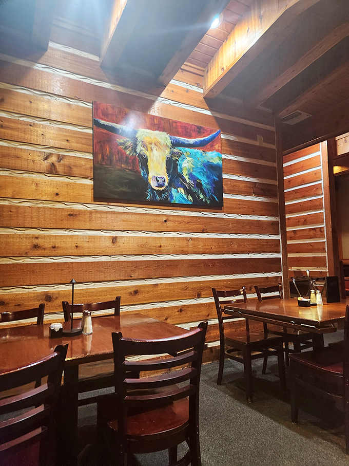 Rustic log cabin walls and colorful bovine artwork create the perfect backdrop for carnivorous adventures. That cow painting isn't judging you… much.