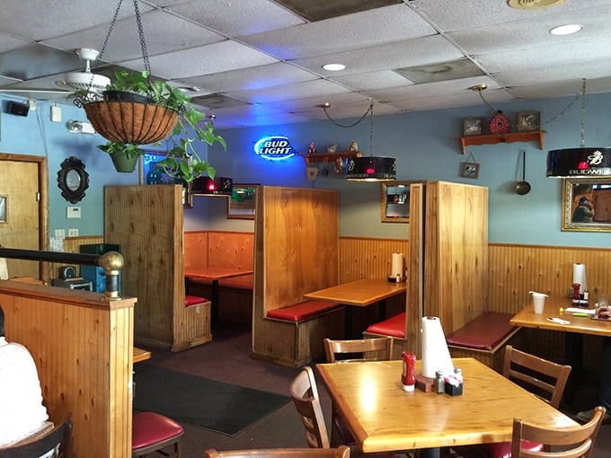 Wooden booths, hanging plants, and that warm glow from beer signs – this isn't interior design, it's comfort architecture at its finest.