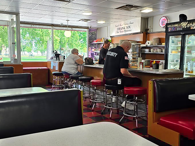 Classic diner counter seating&mdash;where strangers become friends and the staff remembers your order before you've even settled onto those spinning red stools.