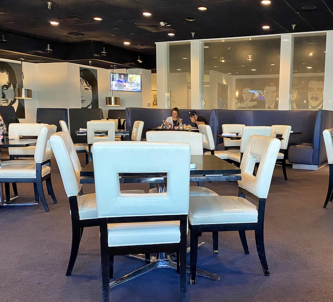 Step inside and you're greeted by a modern twist on classic deli ambiance&mdash;white geometric chairs and blue booths create a space that's both stylish and comfortable.