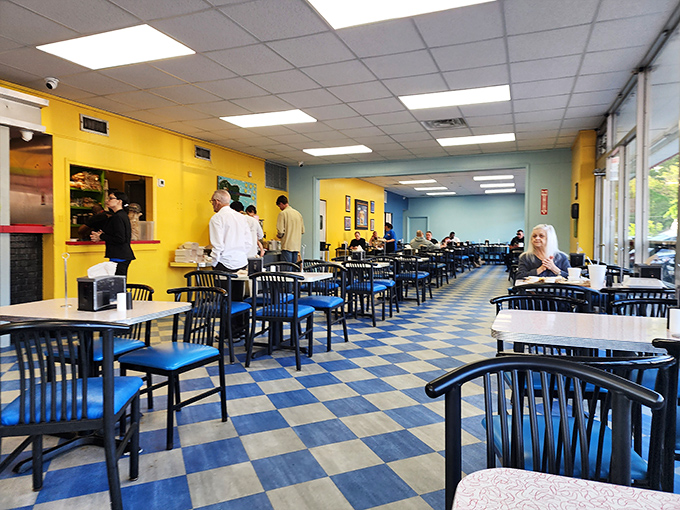Inside, the blue and yellow checkerboard floor and vibrant walls create a cheerful atmosphere where breakfast dreams come true.
