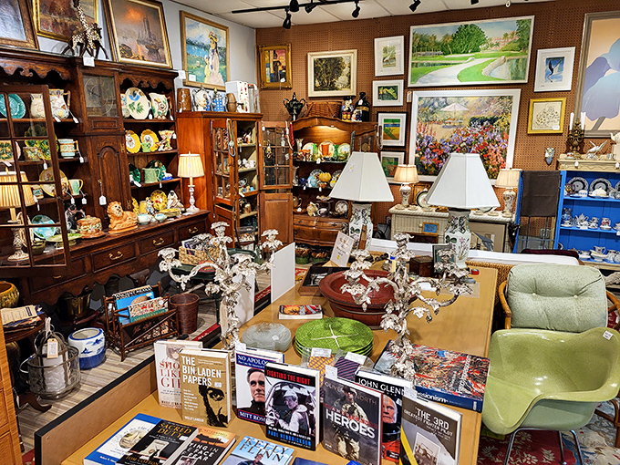 Crystal cabinets flank a cozy sitting area, proving that in the kingdom of antiques, glass displays are merely the gatekeepers to wonderland.