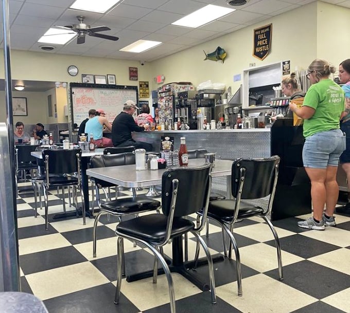 Classic black-and-white checkered floors and chrome-trimmed tables—this is where breakfast dreams and coffee refills live harmoniously.