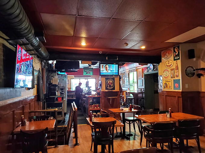 Wooden tables bathed in warm light create the perfect backdrop for conversations that flow as smoothly as the draft beers.