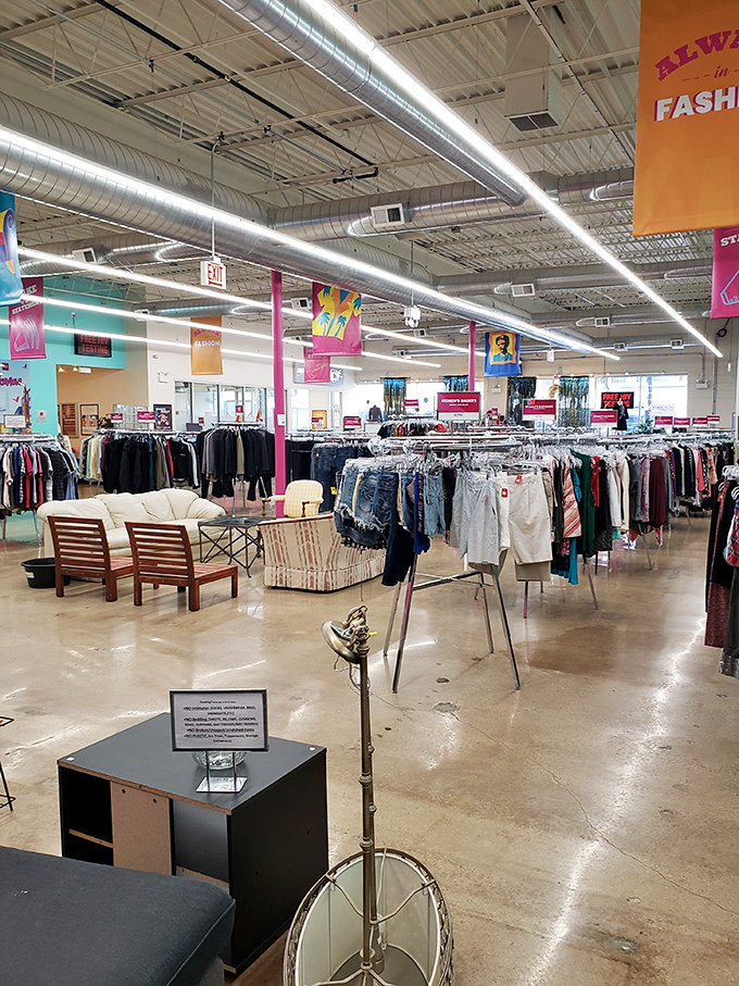 Spacious aisles and organized racks transform thrift shopping from archaeological dig to retail therapy, with colorful banners guiding your treasure hunt.