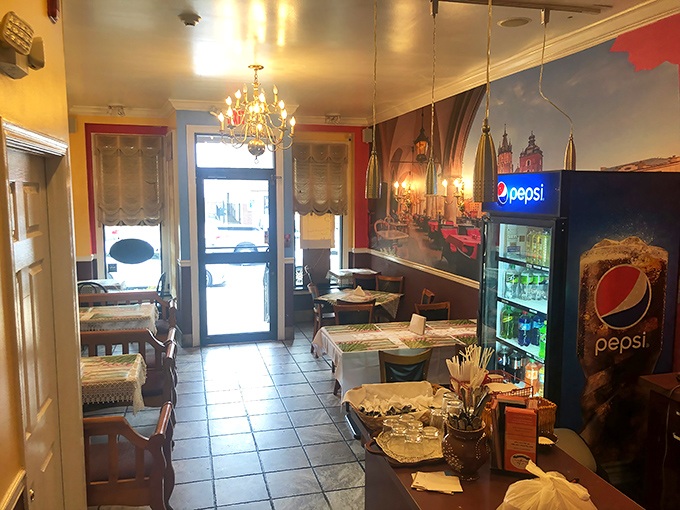 Step inside and you're transported straight to Krakow &ndash; pink tablecloths, wooden chairs, and a mural that's basically a one-way ticket to Poland. 