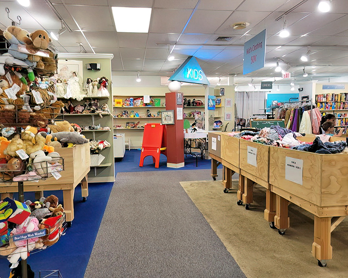 The kids' section: where stuffed animals find second homes and parents find sanity-saving deals. Blue carpet marks the zone of tiny treasures.