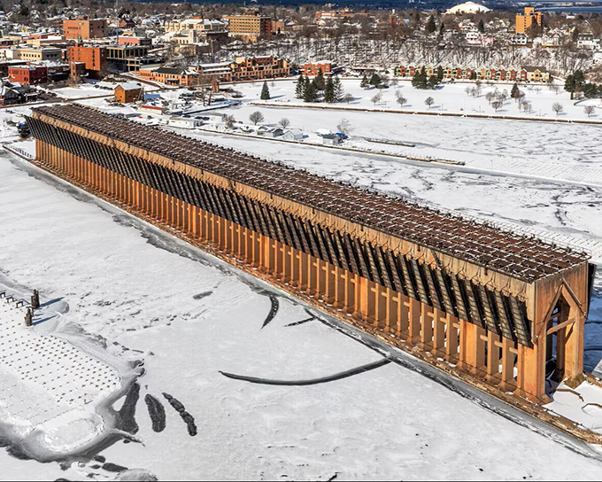 Winter transforms Marquette's ore dock into a snow-framed industrial cathedral, standing as a magnificent reminder of the city's iron mining heritage.