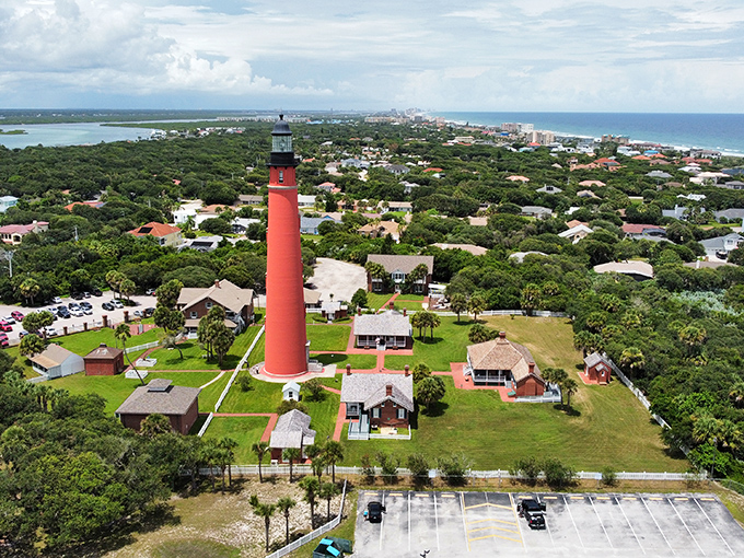 This isn't just any red lighthouse &ndash; it's Florida's oldest, standing sentinel over St. Augustine since 1874, surrounded by lush coastal greenery.
