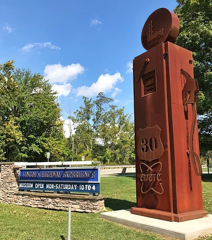 This striking rust-colored gas pump sculpture stands sentinel at the museum entrance, a towering tribute to America's love affair with the open road.