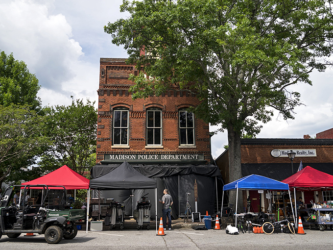 The Madison Police Department building stands sentinel among market tents, a perfect metaphor for this town where history and modern life coexist in charming harmony.