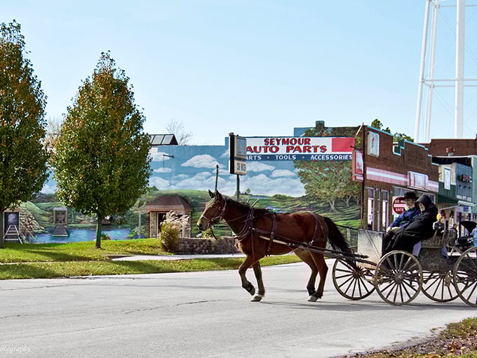 Where modern meets tradition &ndash; an Amish buggy rolls past Seymour Auto Parts, creating a visual timeline of transportation spanning two centuries in a single frame.
