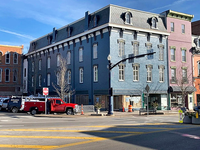 The stately blue building anchors the corner with the kind of architectural details developers would charge you a kidney for in bigger cities.