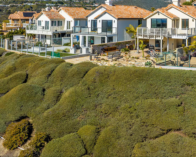 Perched dramatically on coastal bluffs, these Mediterranean-inspired homes offer residents million-dollar views that make mortgage payments seem almost reasonable. Almost.