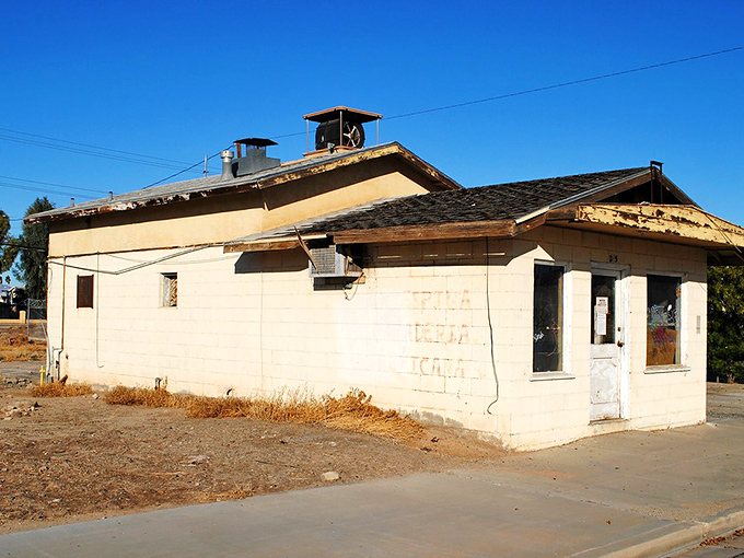 This weathered building tells silent stories of desert perseverance, a humble time capsule baking under the relentless California sun.