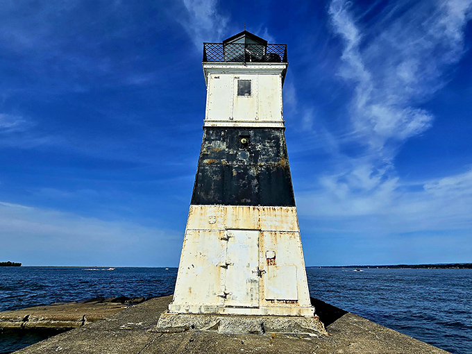 The North Pier Light stands sentinel over Lake Erie's waters, a weathered maritime guardian that's seen more Pennsylvania sunsets than most humans ever will.