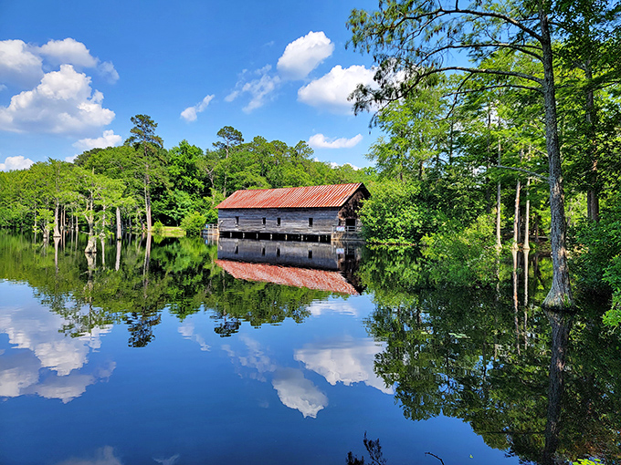 Mirror, mirror on the pond: the historic covered bridge creates perfect reflections, doubling the beauty in this hidden Georgia gem.