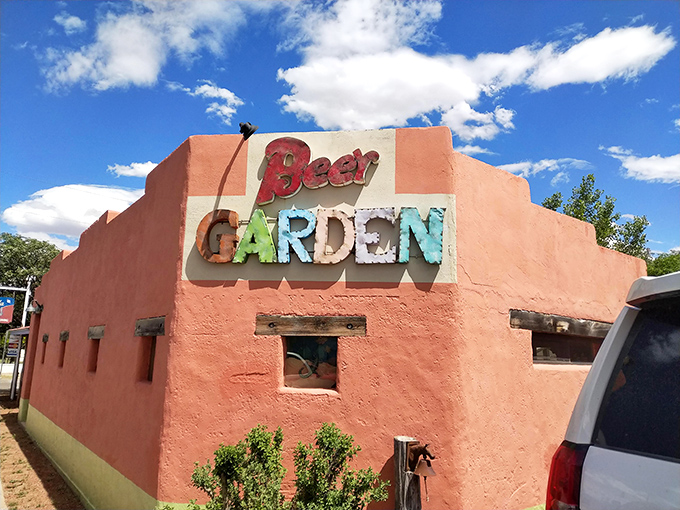 The Beer Garden at Planet Marfa&mdash;where desert thirst meets laid-back vibes in a salmon-colored adobe sanctuary.