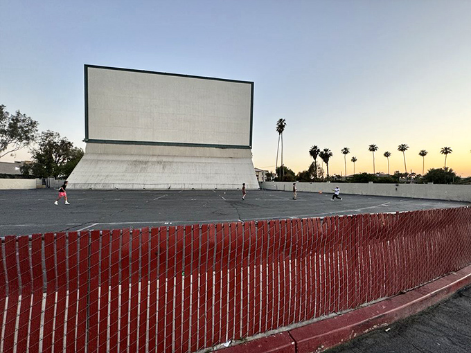 The iconic white screen looms large against the twilight sky, a monument to simpler entertainment that's survived the streaming revolution.