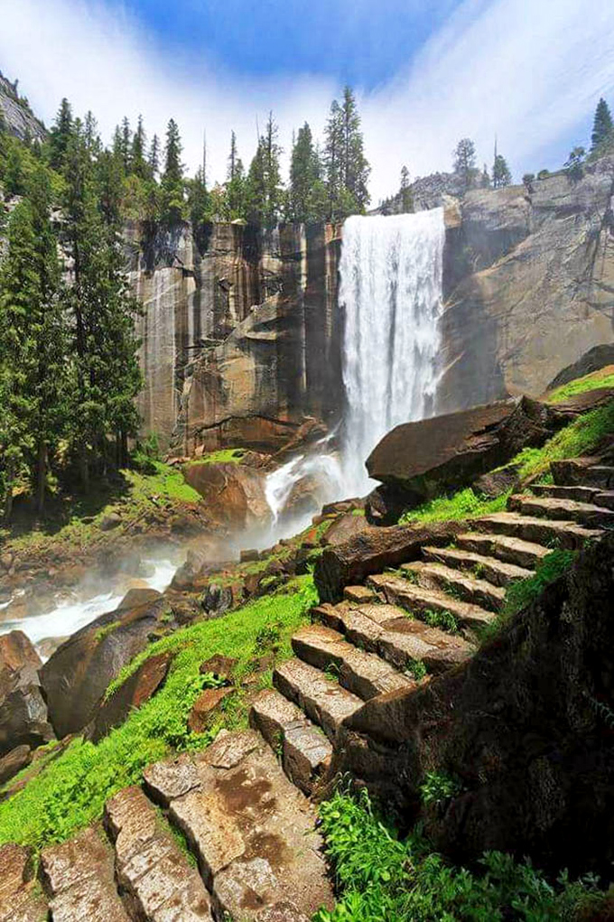 Those granite steps aren't just a trail - they're your stairway to waterfall heaven, literally carved into history.