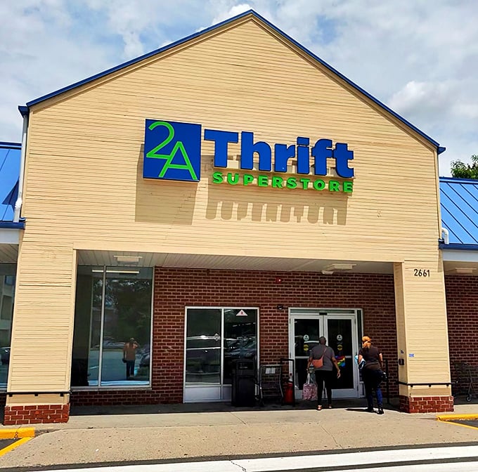 Morning light catches the distinctive blue roof and bright signage, transforming this unassuming strip mall location into a beacon for thrift enthusiasts.