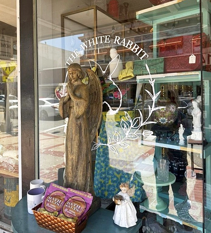 This window display could double as a film set&mdash;where else would you find an elegant angel statue keeping watch over delicate figurines and colorful textiles?