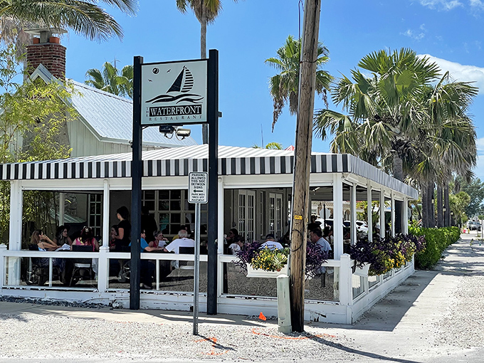 The Waterfront Restaurant's black and white awning isn't just stylish &ndash; it's a beacon for seafood lovers seeking shade and sustenance.