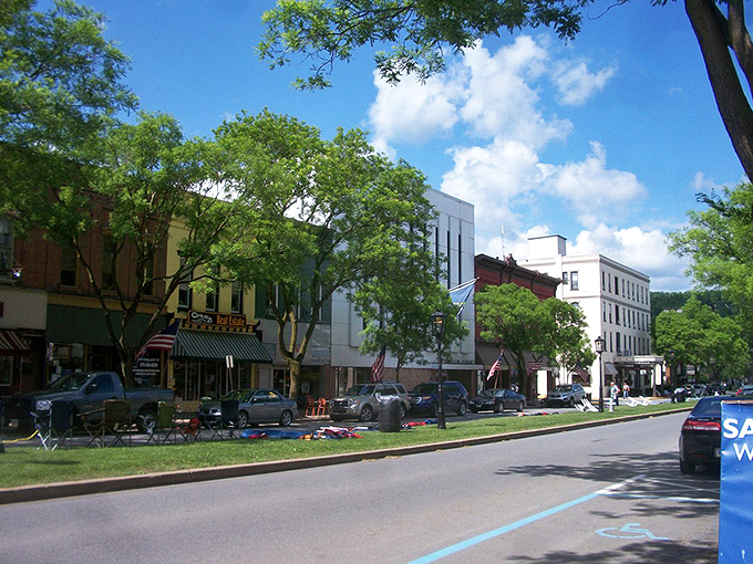 The wide, tree-lined boulevard of Wellsboro's Main Street offers a breath of fresh air with its expansive green median and historic buildings standing proud.