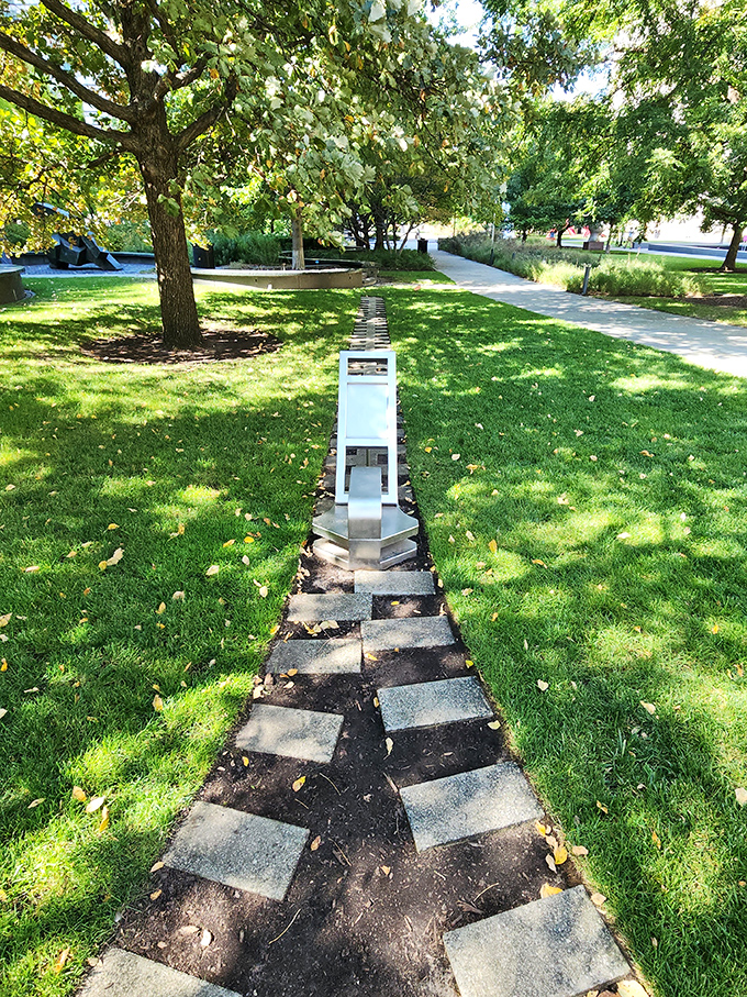 This whimsical pathway invites urban explorers to follow its stepping stones toward unexpected artistic treasures.