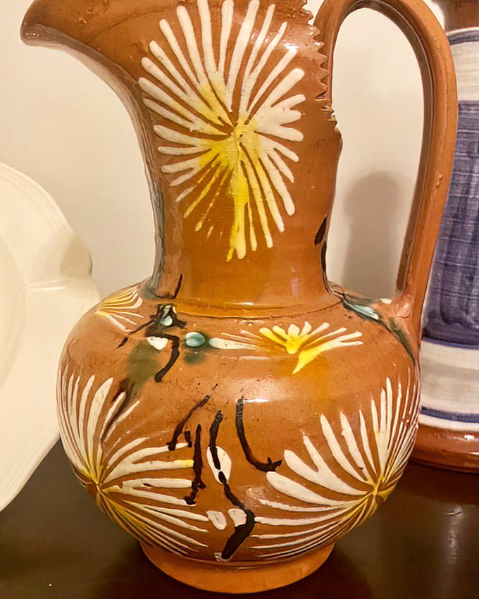 Southwestern artistry at bargain prices! This terracotta pitcher with sunburst designs could easily command gallery prices downtown, but here it's practically giving itself away.