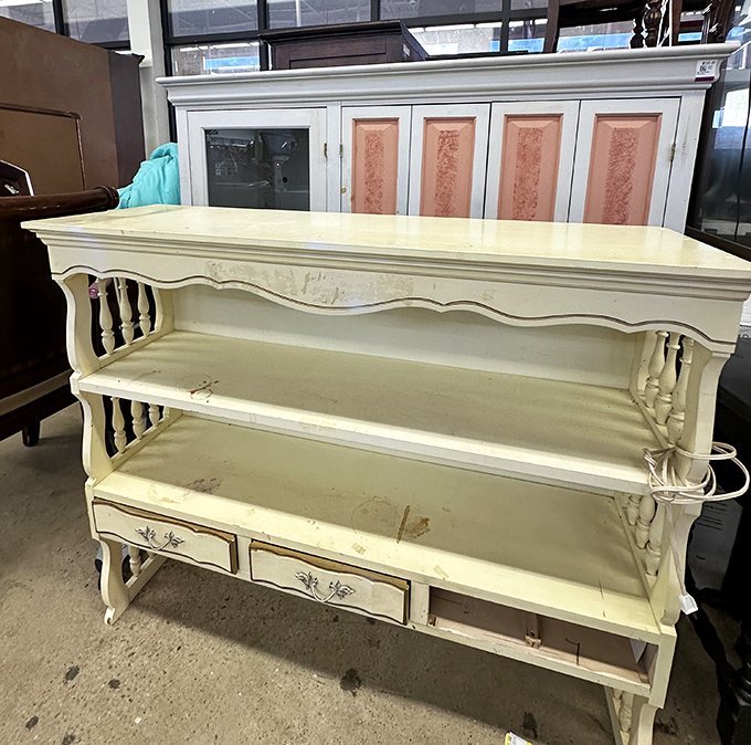 This cream-colored vintage console table whispers tales of dinner parties past while patiently waiting for its next chapter in someone's home.