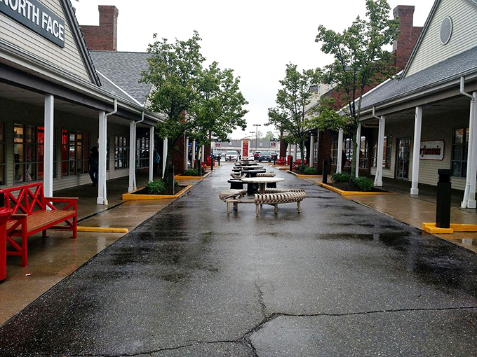 Even on rainy days, the charming walkways between stores invite leisurely exploration. Those red benches aren't just decorative—they're relationship savers.