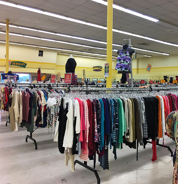 Rainbow racks stretch toward the horizon in the women's section. Each hanger holds not just clothing, but potential new identities.