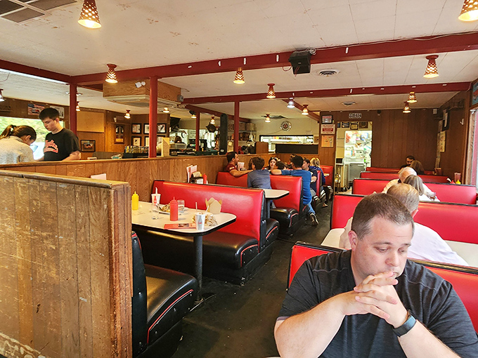 Red vinyl booths worn to comfortable perfection, wood-paneled walls, and the hum of satisfied conversation &ndash; this is diner paradise in its purest form.