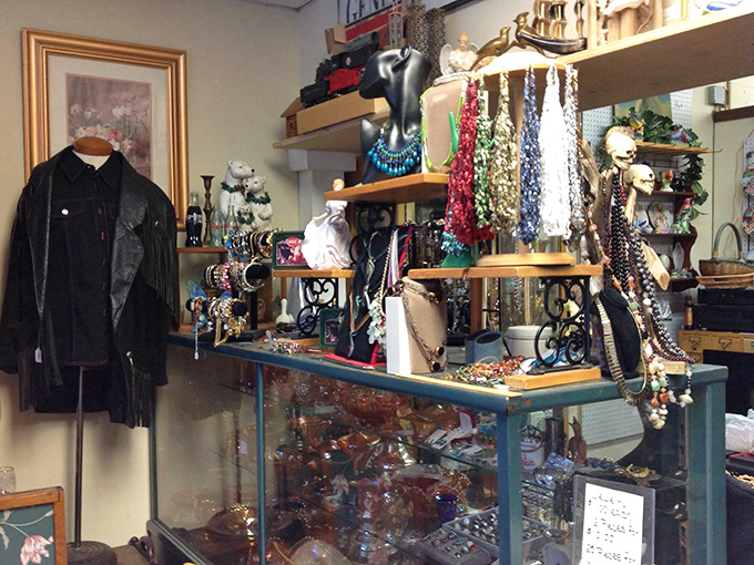 A leather jacket with stories to tell hangs beside a jewelry display where necklaces dangle like colorful memories waiting to be adopted.