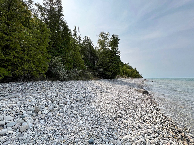 Nature's mosaic of smooth stones and clear shallows creates a meditative shoreline perfect for beachcombers seeking Michigan's hidden treasures.