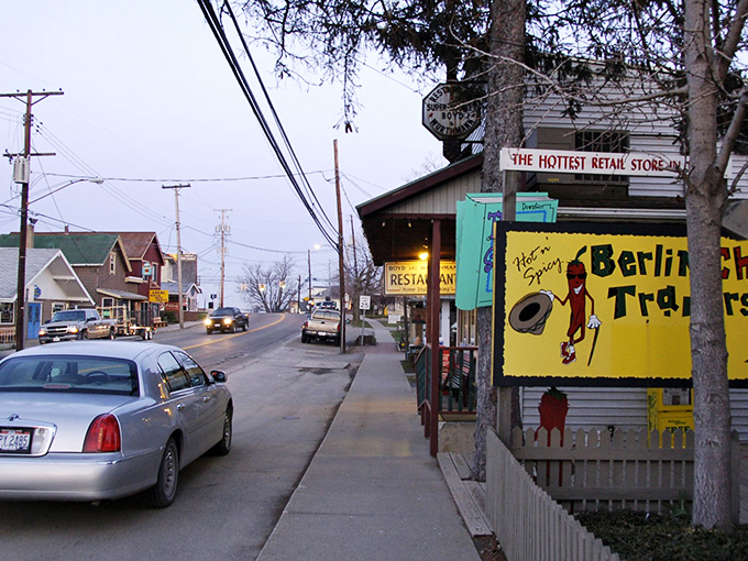 Berlin's main street at dusk captures that magical moment when modern cars and traditional ways coexist in a choreographed dance of two worlds.
