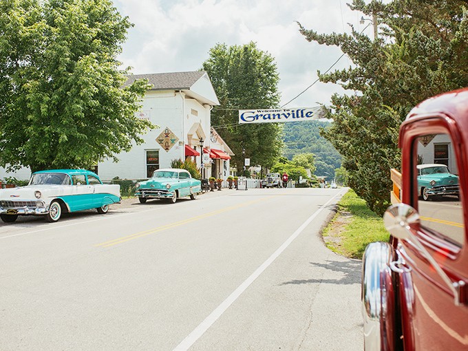Classic cars line Granville's main drag like they never got the memo that the 1950s ended. That turquoise Chevy? Pure automotive poetry.