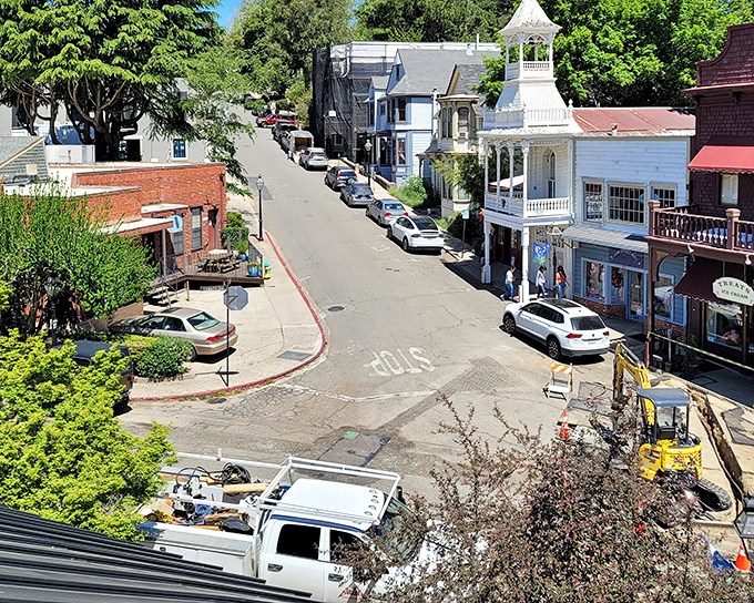 A bird's-eye glimpse of Nevada City's winding streets, where white Victorian buildings pop against the lush greenery like architectural confetti.