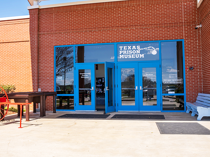 The bright blue doors offer a strangely cheerful gateway into the complex world of Texas corrections history.
